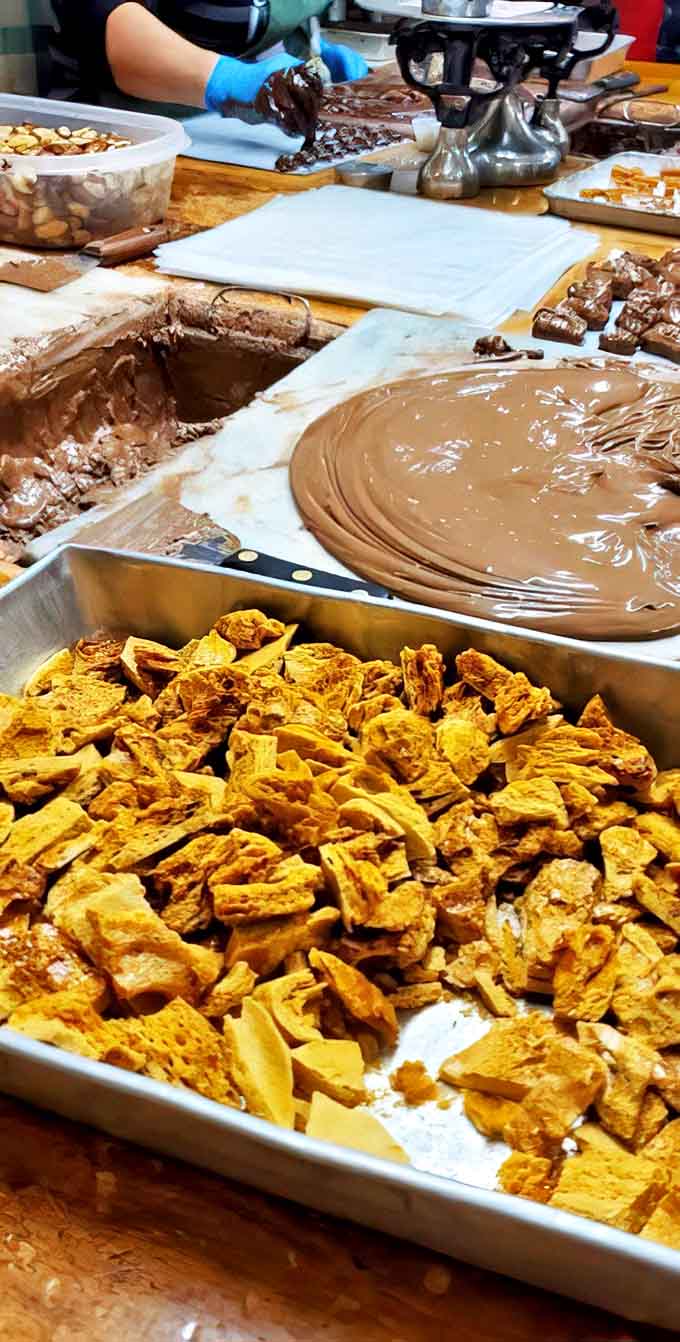 During production: Culinary choreography in action &ndash; where chocolate dreams are born through skilled hands and time-honored techniques.