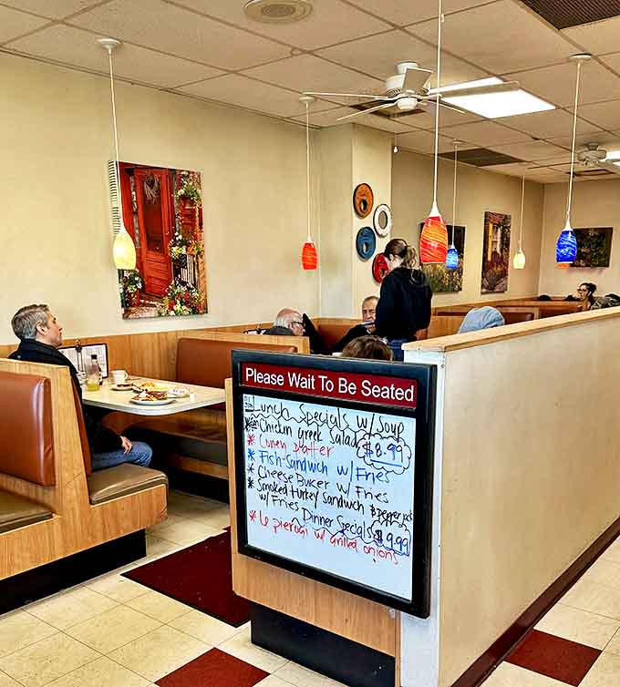 Colorful pendant lights and simple artwork create an unpretentious atmosphere where the food, not the decor, takes center stage.
