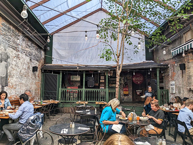 The courtyard at Arnold's transforms into an urban oasis, where brick walls create an intimate atmosphere for enjoying food, drinks, and conversation.