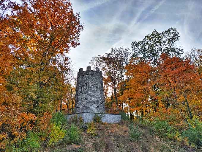 Fiery orange foliage embraces the stone structure, creating a seasonal spectacle that would make New England leaf-peepers green with envy.
