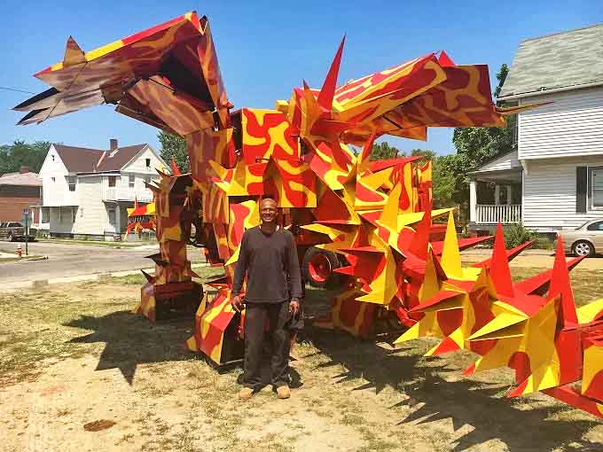 Standing behind the dragon sculpture reveals the impressive scale and engineering required to bring these metal fantasies to life.