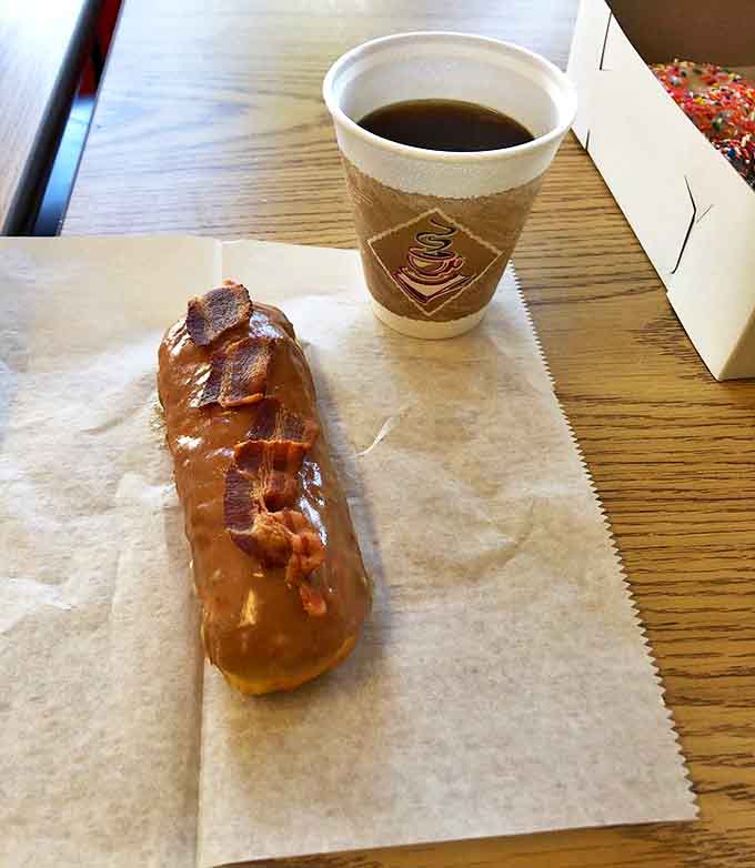 The maple bacon long john &ndash; where sweet meets savory in a donut that should probably require a license to consume.