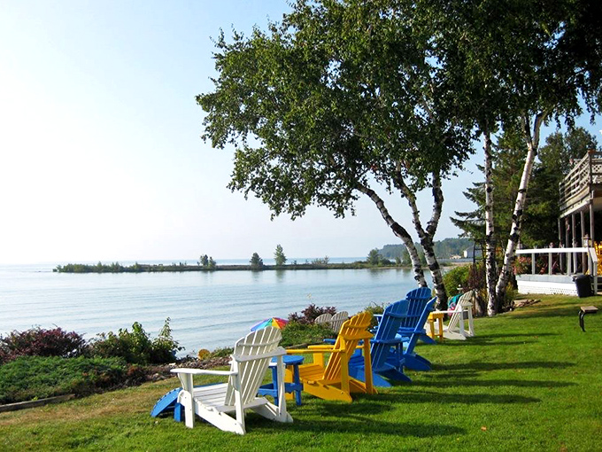 Colorful Adirondack chairs invite you to sit a spell, where the only urgent notification is the lapping of waves against the shoreline.
