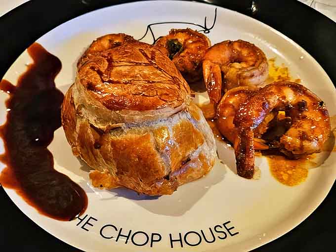 Beef Wellington &ndash; the aristocrat of entr&eacute;es &ndash; wrapped in its golden pastry coat and surrounded by plump, perfectly cooked shrimp.