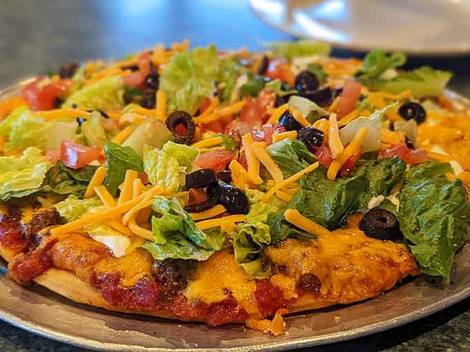 The taco pizza is one of those beautiful fusion creations that sounds crazy until you taste it, then suddenly makes perfect sense.