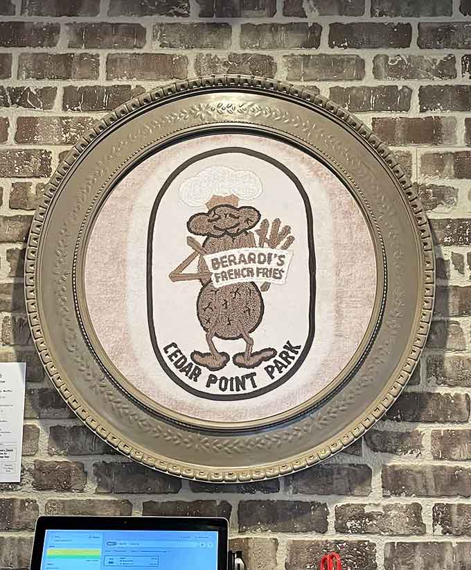That vintage Cedar Point platter on the wall connects diners to local history while they create their own food memories.
