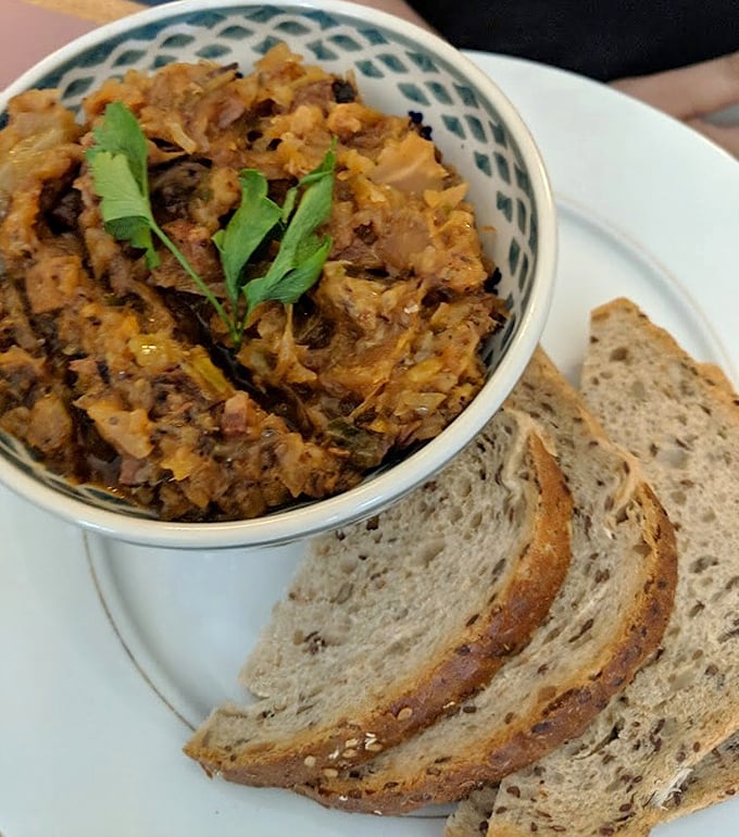 Hunter's stew that's been simmering since medieval times, paired with hearty rye bread for the ultimate Polish comfort food experience.