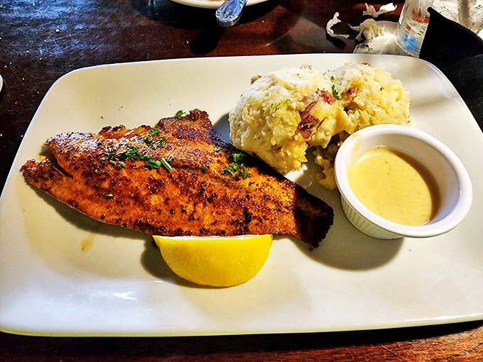 Blackened redfish with a side of potato salad &ndash; proof that simplicity, when executed with skill and quality ingredients, creates culinary magic.