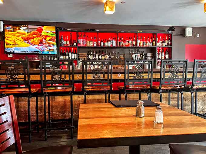 The bar area glows with inviting warmth, offering a perfect perch for solo diners or couples seeking a casual meal.