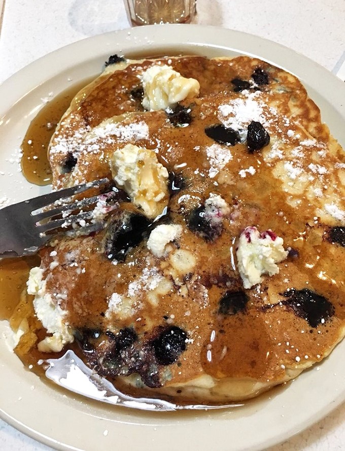 These blueberry pancakes, dotted with bursts of fruit and dusted with powdered sugar, make breakfast feel like an occasion worth celebrating.