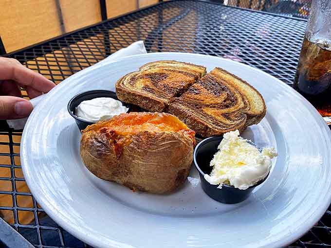 Their famous marble rye sandwich alongside a loaded baked potato &ndash; carb heaven that's worth every delicious, indulgent bite.