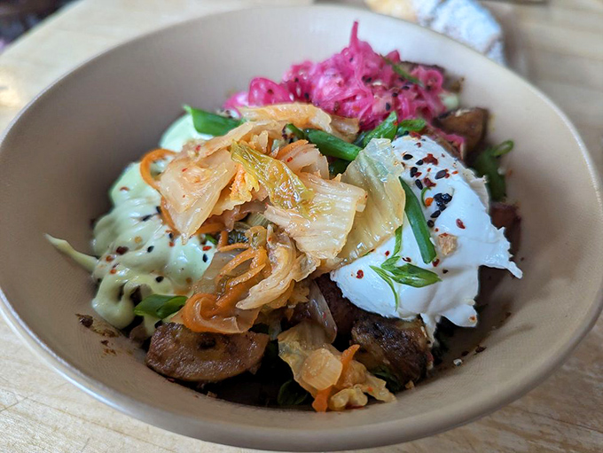 This breakfast bowl balances vibrant pickled vegetables with savory proteins and fresh greens, proving healthy can also be delicious.