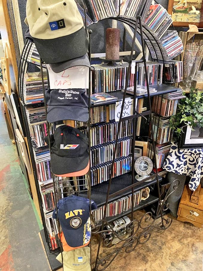 Music and memories share space as vinyl albums stand at attention while vintage caps hang above – each representing someone's glory days.