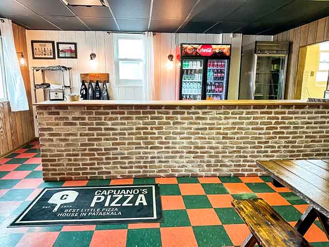 The brick counter separates you from the magic happening in the kitchen, where fresh dough becomes pizza and subs become legendary.