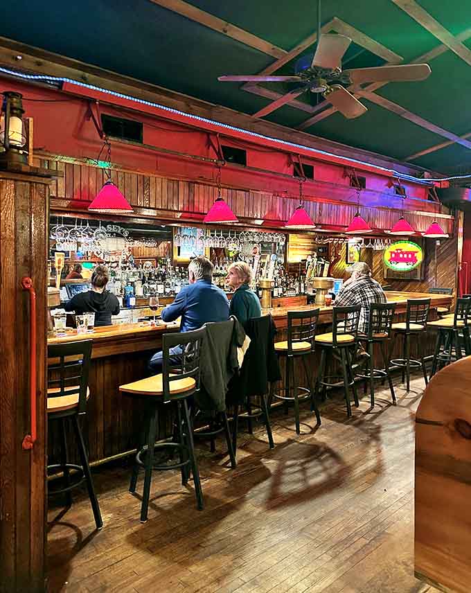 The bar area beckons with its polished wood and hanging glassware, ready to serve cold drinks alongside hot pretzels.