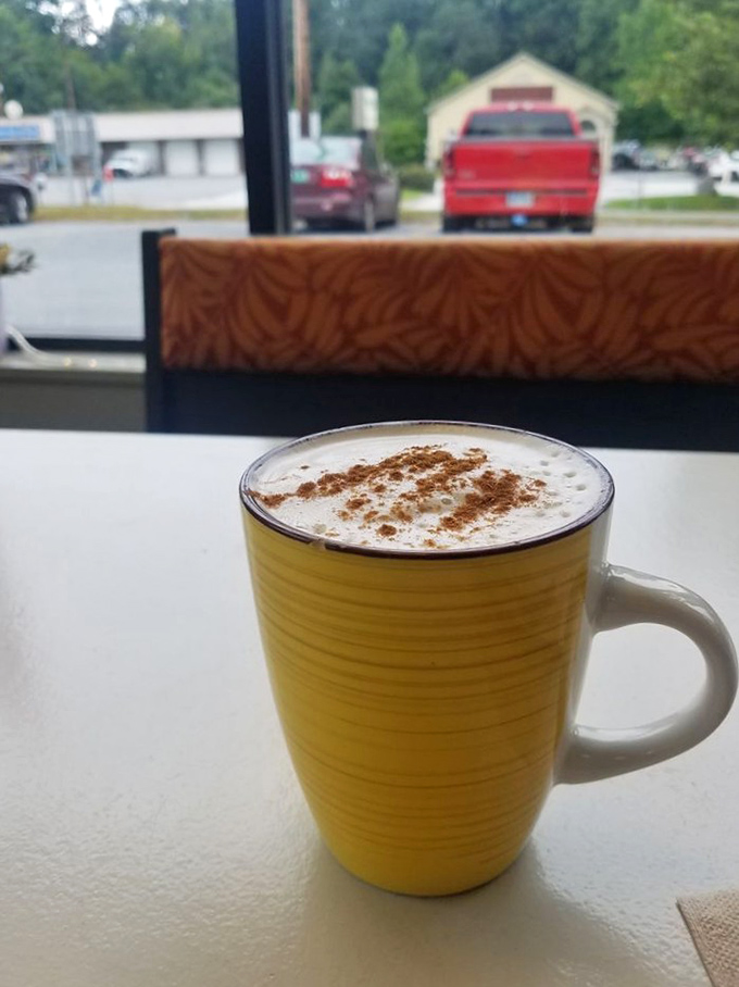 That's not just any chai latte – it's a warm hug in a sunshine-yellow mug, topped with cinnamon that dances across the foam.