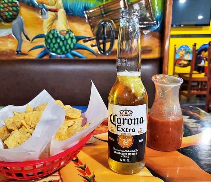Chips with House Salsa and Corona Extra: The holy trinity of Mexican restaurant starters &ndash; crispy chips, vibrant salsa, and an ice-cold Corona with lime.