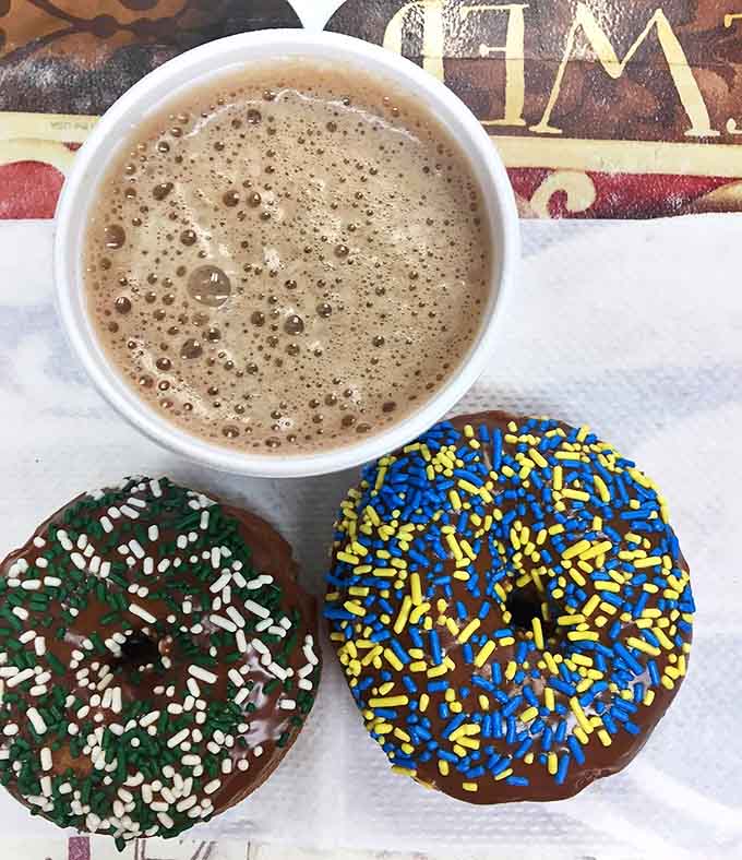 Michigan mornings don't get better than this: chocolate-frosted donuts with team-colored sprinkles alongside steaming hot coffee.