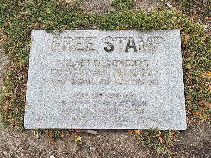 The plaque details the Free Stamp's journey from corporate commission to beloved public art installation, a story as interesting as the sculpture itself.