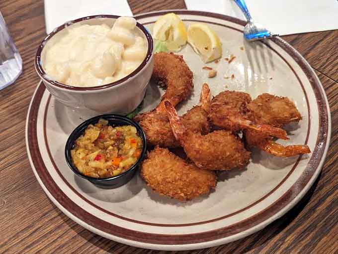 Coconut shrimp arrives golden and crispy with dipping sauce, offering a tropical twist that transports you straight to island time.