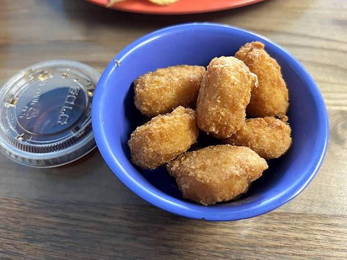Golden corn puffs filled with creamy corn &ndash; a side dish that could easily steal the spotlight if the meat weren't so magnificent.