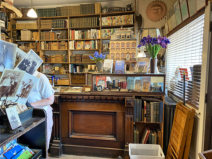 Antique furniture and carefully curated displays create intimate vignettes throughout the store, inviting browsers to linger and explore.