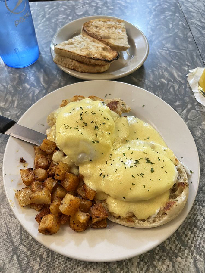 Hollandaise sauce cascades over poached eggs in this Crabby Benedict, where the ocean meets Vermont on a perfectly toasted English muffin.