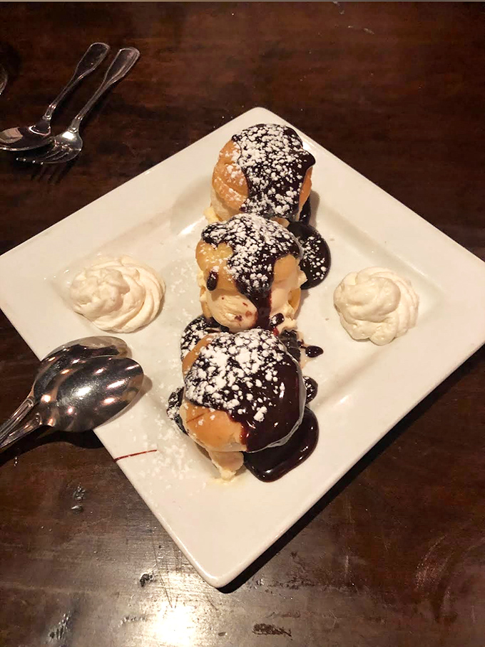 These powdered-sugar-dusted pastry pillows aren't just dessert, they're edible happiness with chocolate sauce and whipped cream companions.