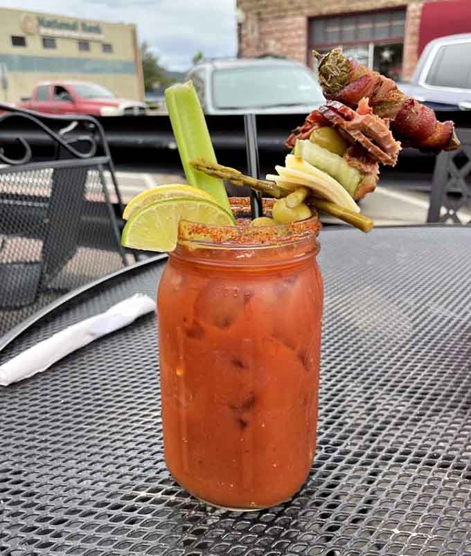 That Bloody Mary comes loaded with enough garnishes to qualify as both drink and appetizer in one glorious glass presentation.