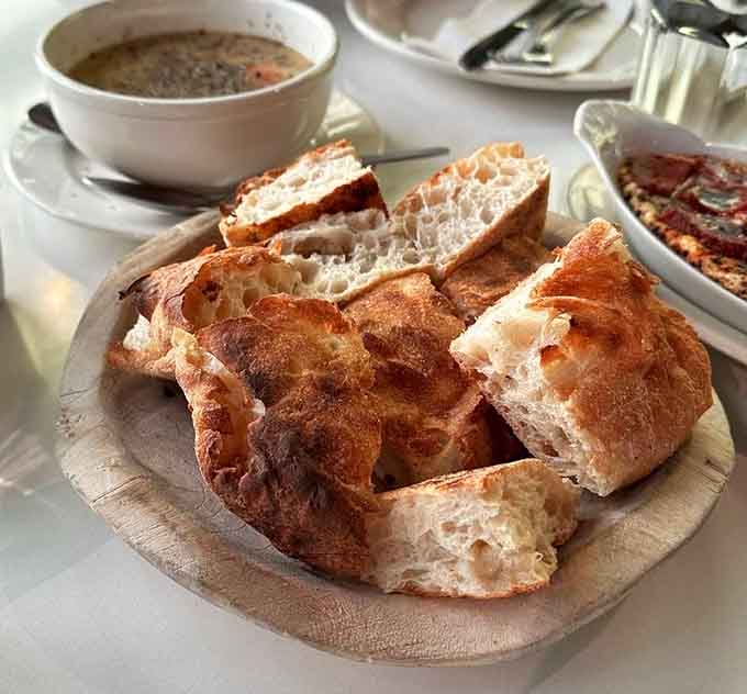 Fresh Pide bread emerges from the wood-fired oven with blistered, charred perfection that makes every dip better.