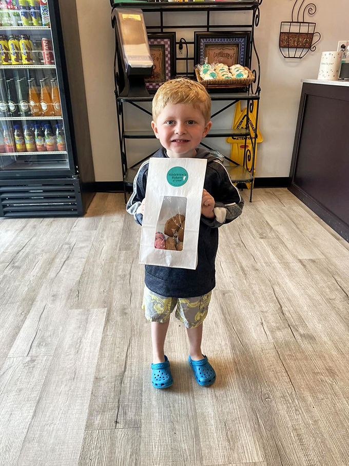 The universal language of joy&mdash;a young customer clutches his bakery bag like he's won the childhood lottery.
