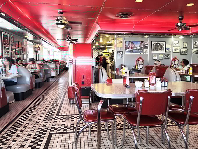 Happy customers tucked into cozy booths enjoy the perfect balance of privacy and people-watching that makes diner dining so satisfying.