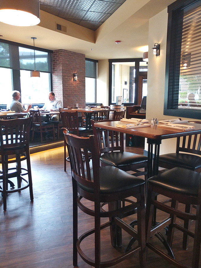 Natural light floods the corner seating area, making it the perfect spot for a leisurely weekend brunch or afternoon pint.