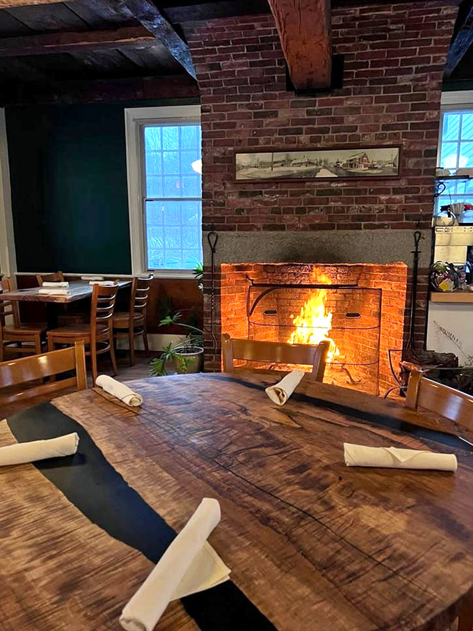 A crackling fireplace adds rustic charm to this dining area, making winter meals feel like a warm embrace.