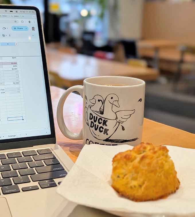 That branded mug and fresh scone combo is the official uniform of people who've figured out this whole work-life balance thing.