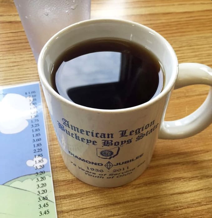 Coffee served in a commemorative mug, because even your beverage container should tell a story while you're caffeinating your way to consciousness.