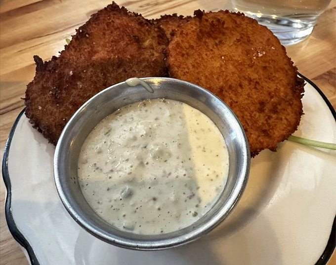 Golden-crusted green tomato slices with creamy dipping sauce &ndash; tangy, crispy perfection that would make Fannie Flagg proud.