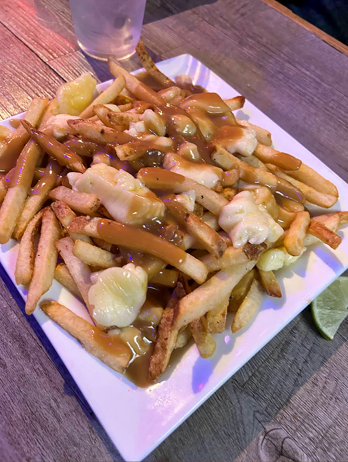 Poutine: French fries living their best life, smothered in gravy and cheese like they've won the lottery.