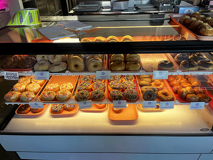 The glowing display case showcases donuts so beautiful they almost seem too good to eat, almost.