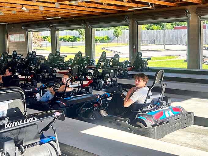 The indoor staging area houses rows of go-karts waiting for their next drivers, like mechanical steeds ready for battle.
