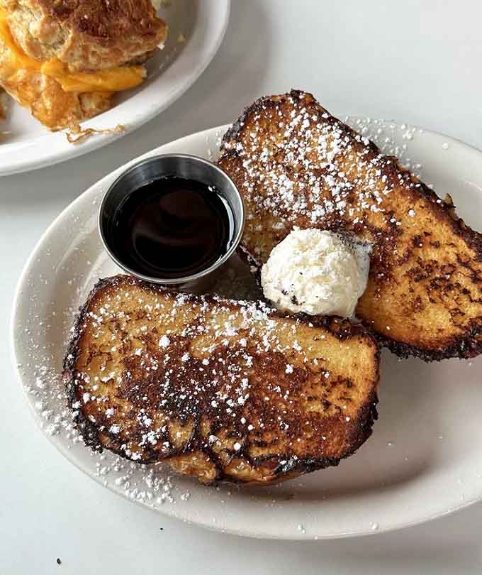 French toast at Hi-Lo arrives golden and dusted with powdered sugar, thick slices that prove sometimes the classics really are classic for good reason.