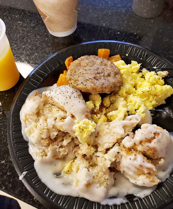 Biscuits and gravy done right, with fluffy biscuits drowning in creamy, peppery gravy that'll make you reconsider your breakfast routine entirely.