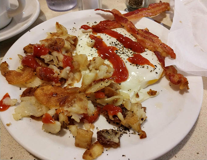 Crispy, golden potato perfection topped with eggs and bacon&mdash;breakfast architecture that deserves its own appreciation society.