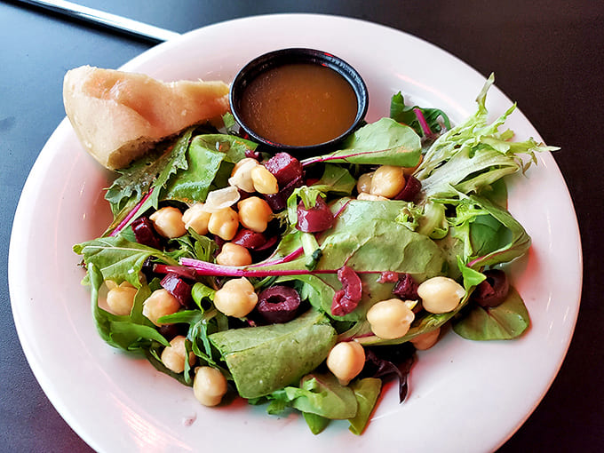 Proof that salads needn't be boring! Crisp greens, plump chickpeas, and briny olives create the perfect pizza prelude.