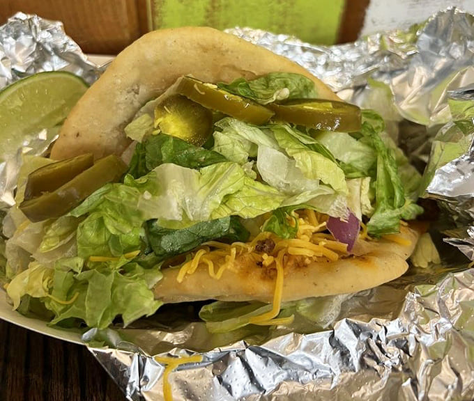 The fry bread taco showcases Indigenous culinary traditions, loaded with toppings that honor Minnesota's cultural heritage beautifully.