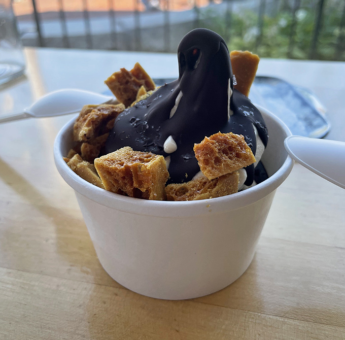Honey soft serve wearing a chocolate shell like a fashionable hat, with honeycomb chunks adding crunch to each cool, creamy spoonful.