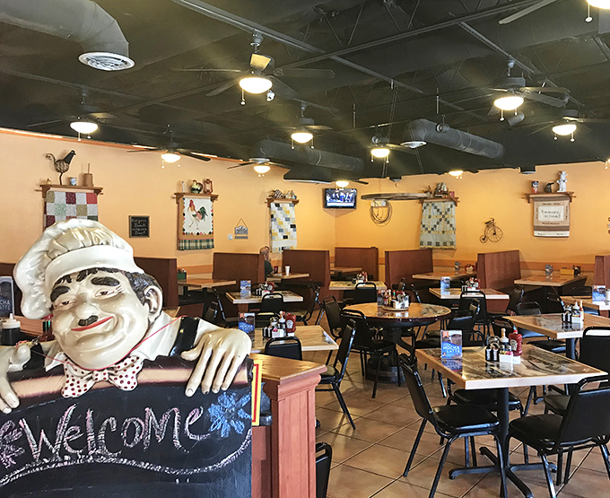 Warm yellow walls and rooster-themed d&eacute;cor create that perfect "grandma's kitchen" vibe that makes every meal feel like a homecoming.