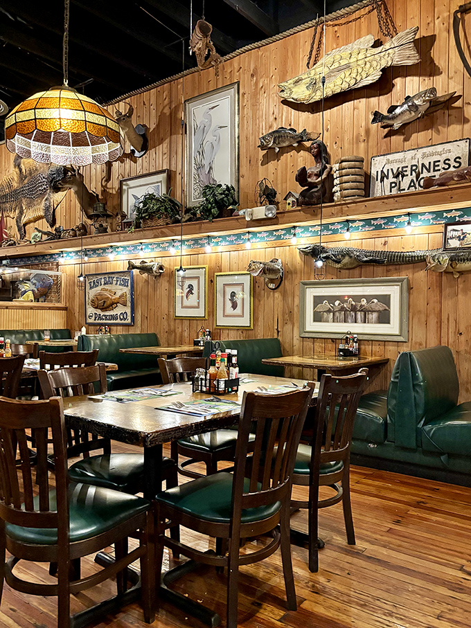 Wooden walls adorned with mounted fish and nautical treasures create an immersive dining experience that feels authentically Floridian.
