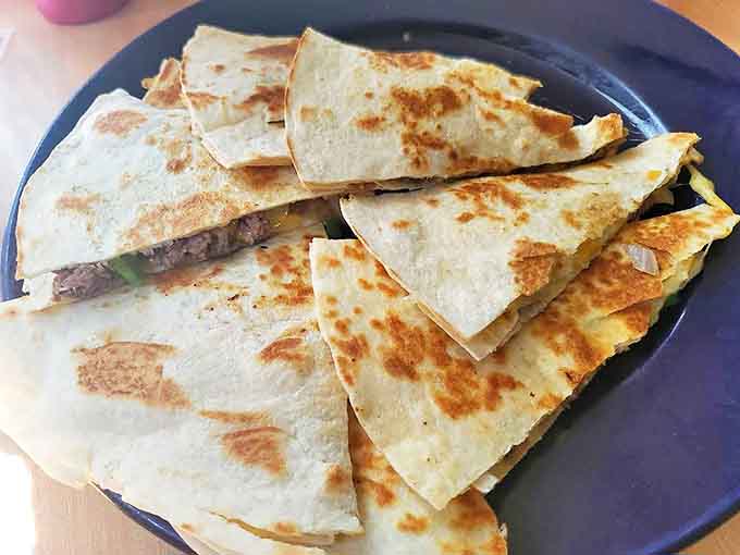 Beef Quesadilla: Crisp tortilla triangles revealing a treasure of seasoned beef and melted cheese that stretches dramatically with each bite.