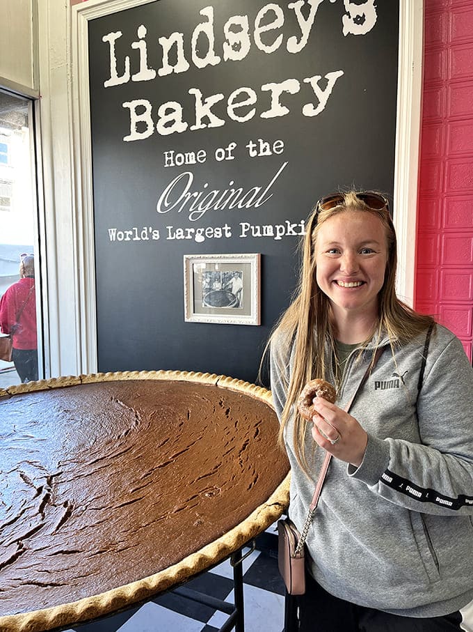Nothing captures pure joy quite like someone standing next to a pie that's roughly the size of a small swimming pool.
